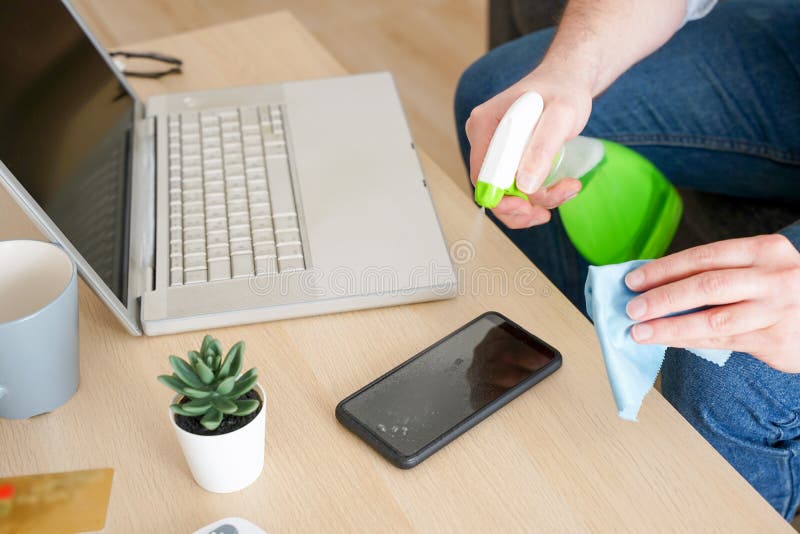 Close Up of Man Cleaning and Sanitizing Tech Devices Stock Photo ...