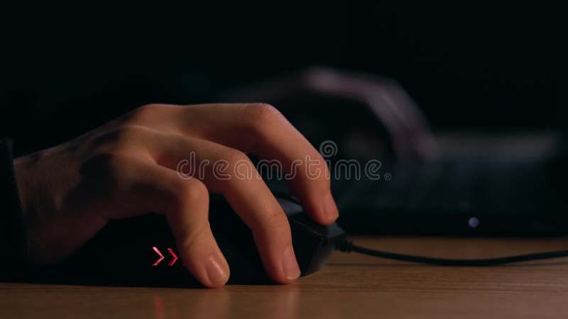 Close Up of Man Gamer Hands Using Computer Mouse is Playing Video Game at Night. Male Hacker ...