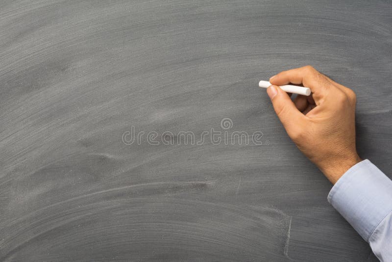 Close Up of Man Hand Holding Chalk Against Blank Black Chalkboard Stock ...