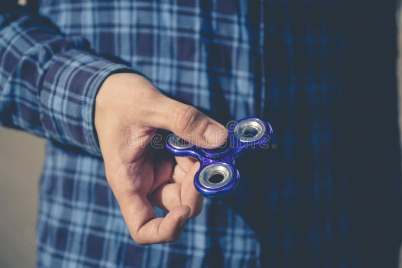Close Up of Man Hand Playing with Fidget Spinner Stock Photo - Image of ...