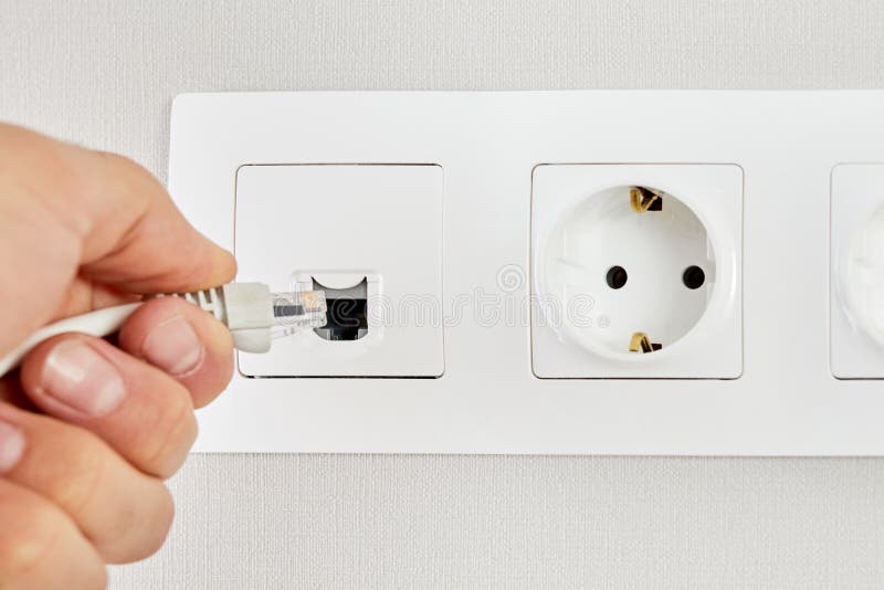 Close Up of a Man Hand Plugging an Ethernet Cable into a Wall Socket ...