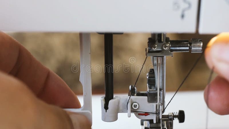 Close Up of Man Hand Threading Thread into Needle of Sewing Machine ...