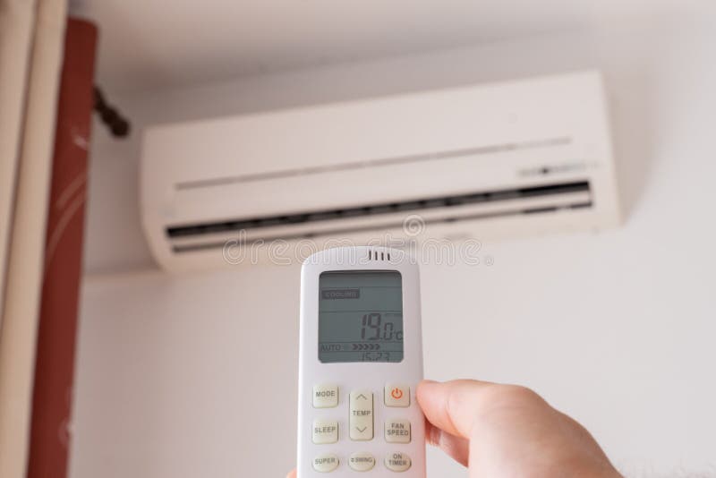 Close-up of Man Hand is Turn-on Air Conditioner Split Type by Remote ...