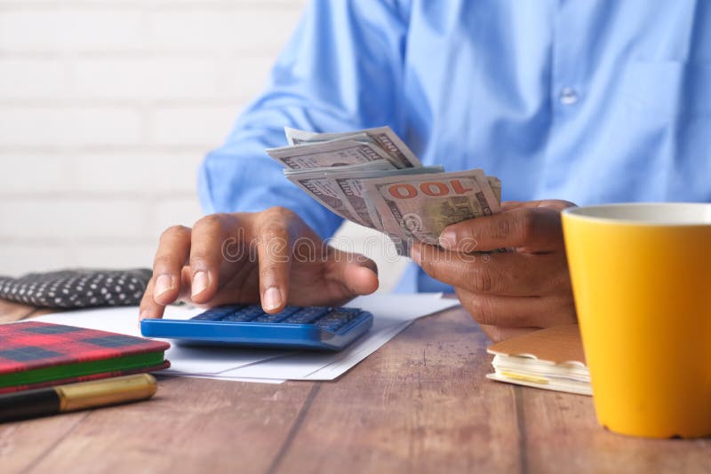 Close Up of Man Hand Using Calculator and Holding Us Dollar Stock Image ...
