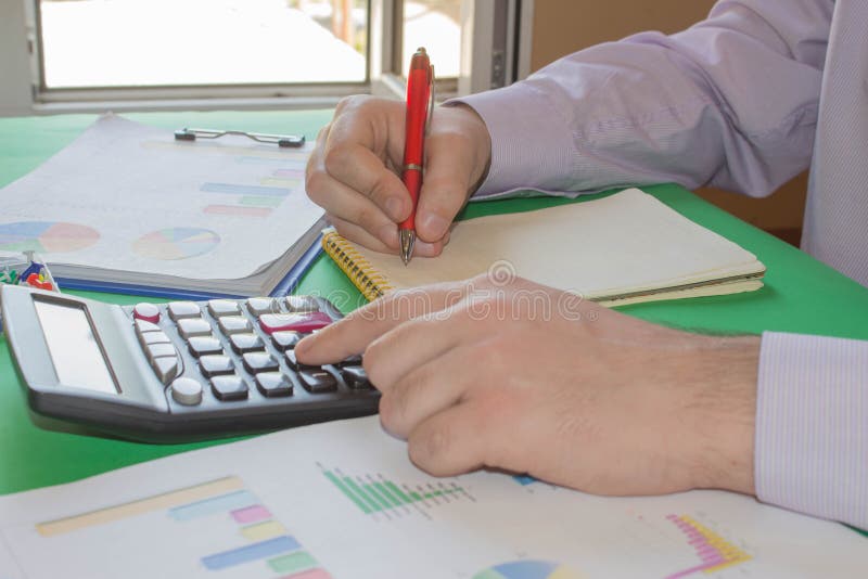 Close Up Man Hand Using Calculator and Writing Make Note with Calculate ...