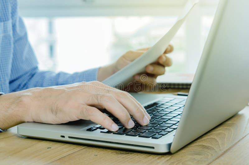 Close-up Man Hand Using Computer Laptop and Finance Document. Stock ...