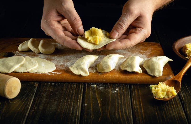 Close-up of a Man Hands Making Dumplings on the Kitchen Table for ...