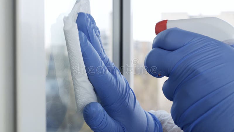 Close Up Man Hands With Protection Gloves Cleaning A Window Using