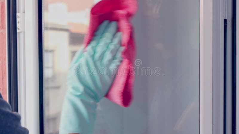 Close Up Man Hands with Rubber Gloves Cleaning a Window Using Sprayed ...