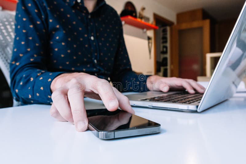 Close Up of Man Hands Using Laptop Checking Smart Phone Stock Image ...