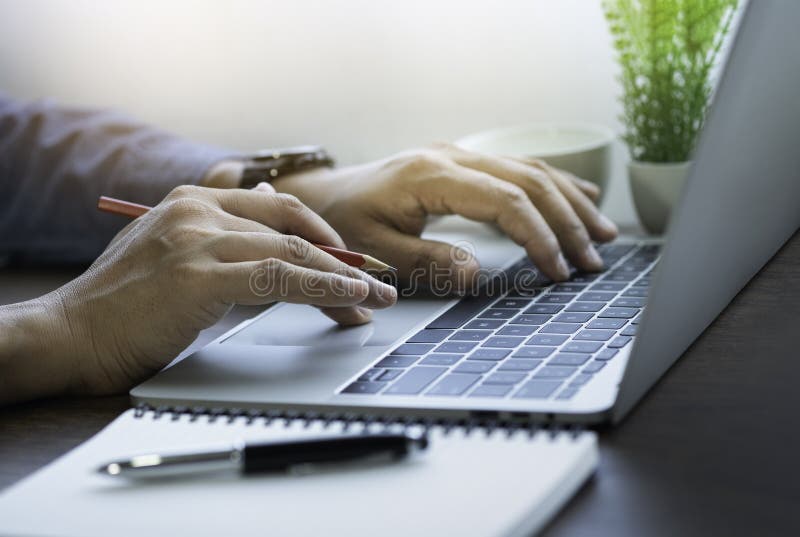 Close-up of Man Hands Using and Typing Keyboard of Laptop Computer on ...
