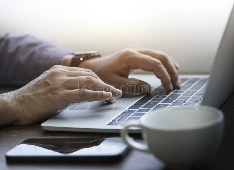 Close-up of Man Hands Using and Typing Keyboard of Laptop Computer on ...