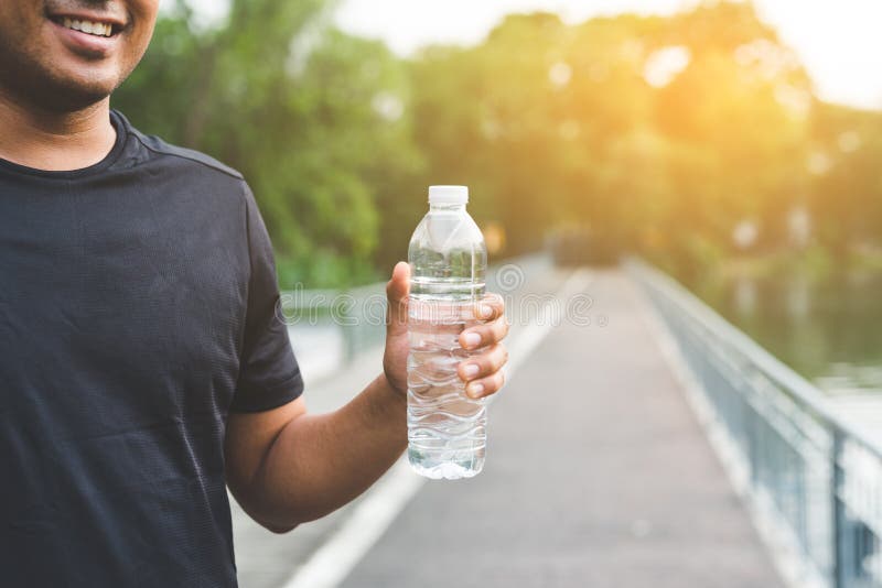 Man Holding Bottle of Water Stock Image - Image of outdoor, indonesian ...