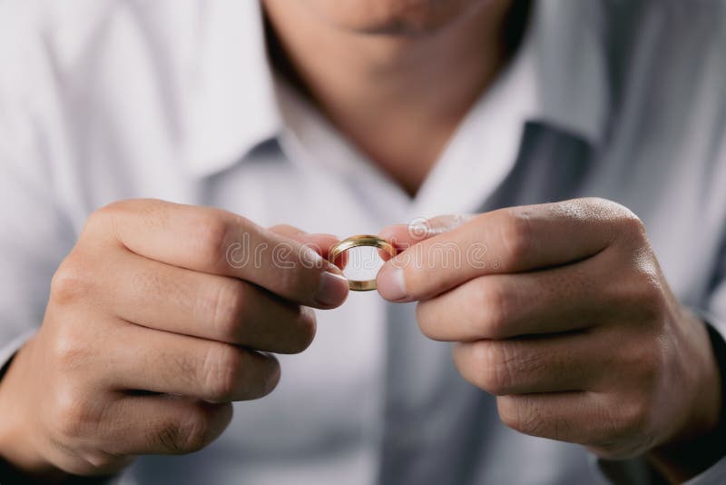Close-up of Man Holding Ring at Home, Thinking about Wedding Stock ...