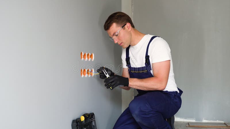 Close Up of Man Installing Electrical Outlet in Wall in Room of House ...