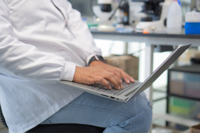 Close-up of Man in Lab Coat Using Laptop Computer in Lab Stock Photo ...