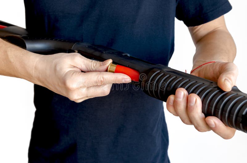 Close Up of Man Loading a Red Shotgun Shell into the Magazine of His ...