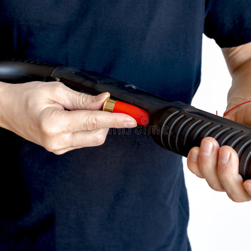 Close Up of Man Loading a Red Shotgun Shell into the Magazine of His ...