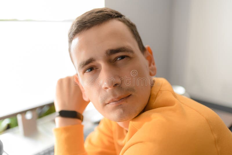 Close Up of Man with Meticulous Expression Looking at Camera Sitting at ...