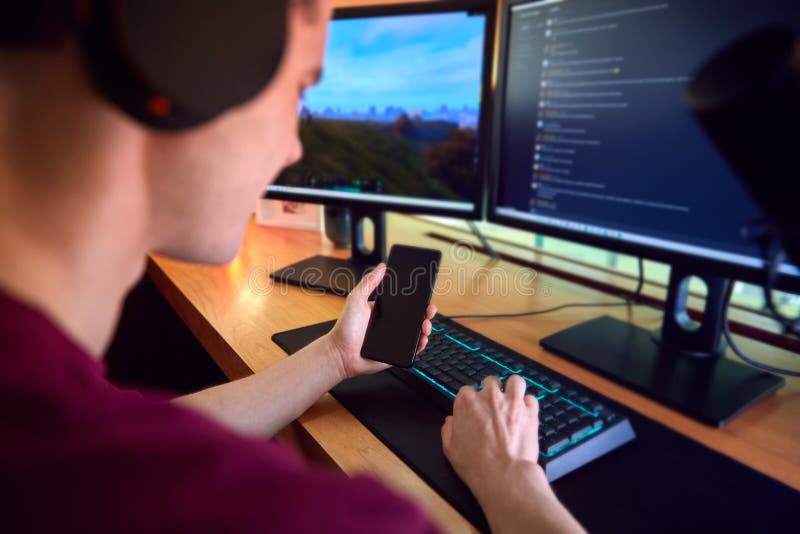 Close Up of Man with Mobile Phone Gaming at Home Sitting at Desk with ...