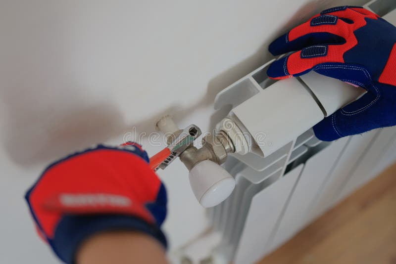 Man Plumber Installing Heating Radiator in Apartment or House Stock ... Man Plumber Installing Heating Radiator in Apartment or House Stock ...
