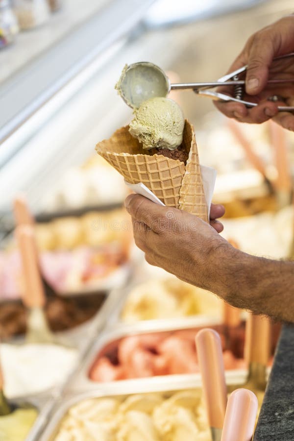 Close-up of a Man Preparing a Multi Flavored Ice Cream Cone Stock Photo ...