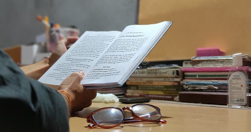 Close Up of a Man Reading Book on Study Table, Stock Image - Image of ...