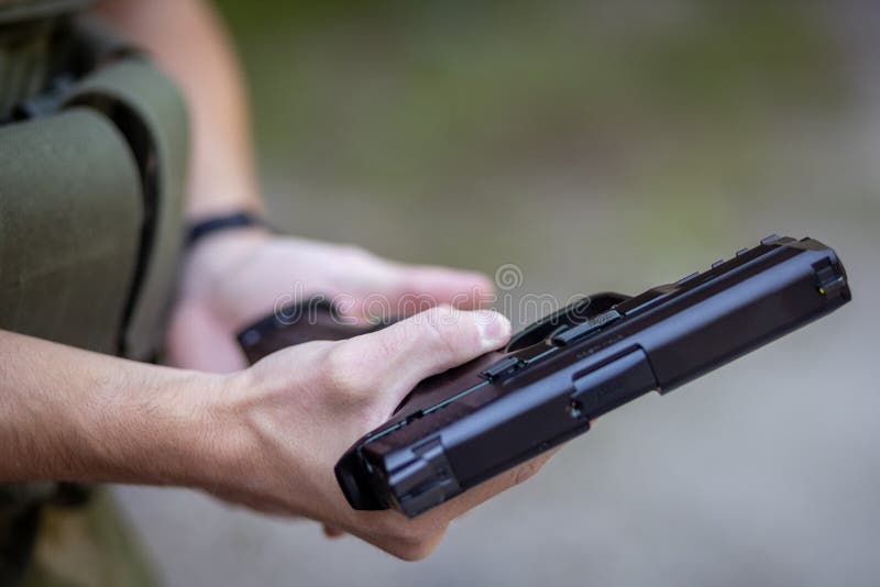 Close Up of a Man Reloading an Airsoft Pistol Stock Image - Image of ...