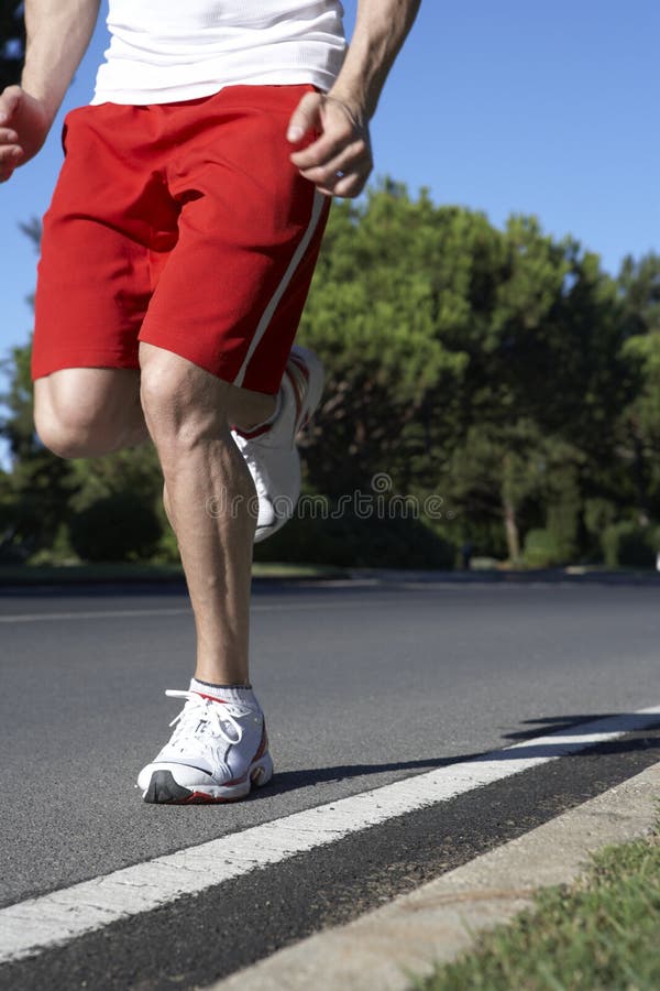 Close Up of Man Running on Road Stock Image - Image of street, road ...