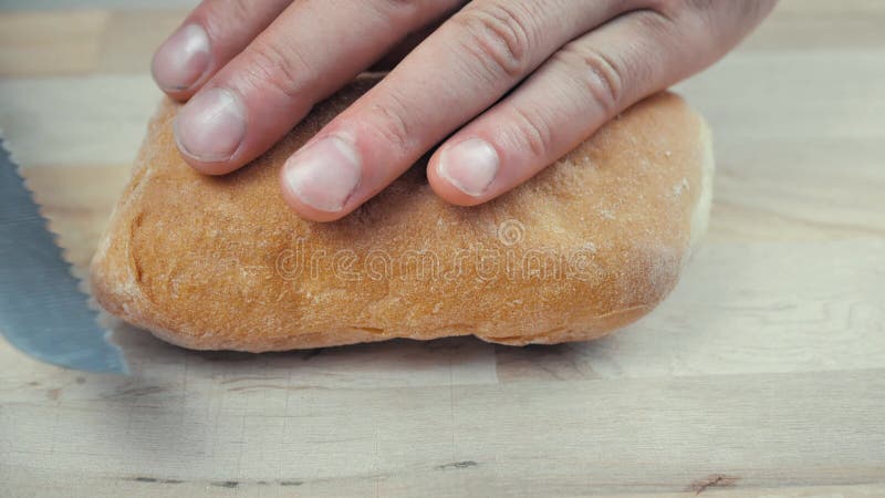 Close-up of a Man S Hand Cutting a Burger Bun in Half with a Sharp ...