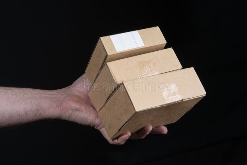 Close-up of Man S Hand Holding Three Small Corrugated Cardboard Boxes ...