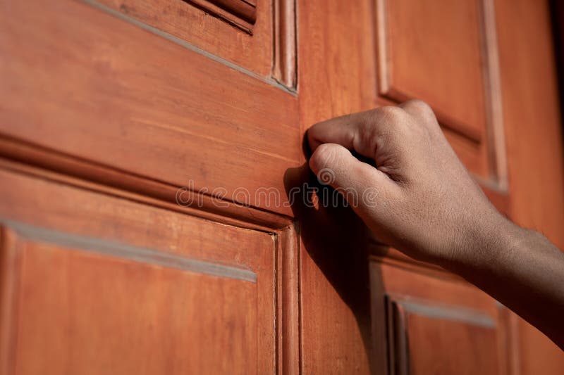 Hand knocking on the door stock image. Image of hand - 328693243