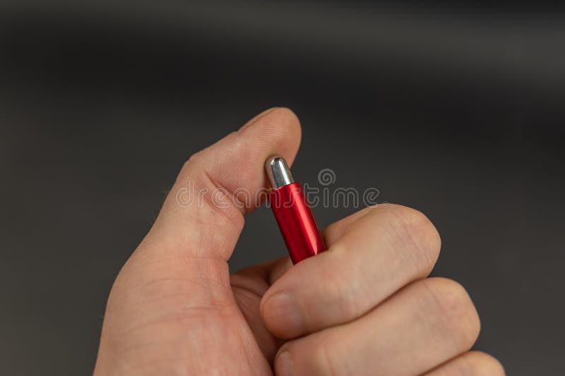 Close-up of a Man`s Hand Pressing a Ballpoint Pen Button. the Thumb of ...