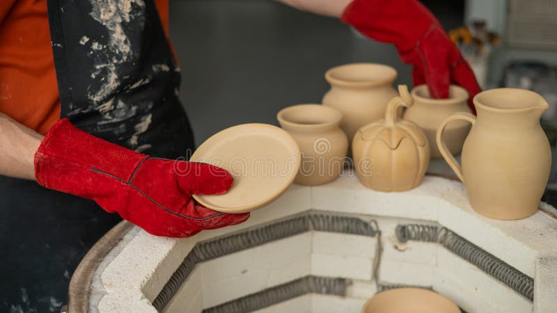 Close-up of a Man& X27;s Hands Loading Ceramics into a Special Kiln ...