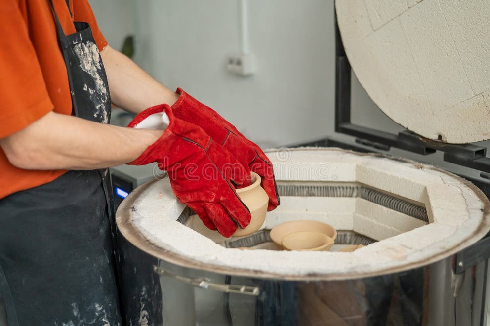 Close-up of a Man& X27;s Hands Loading Ceramics into a Special Kiln ...