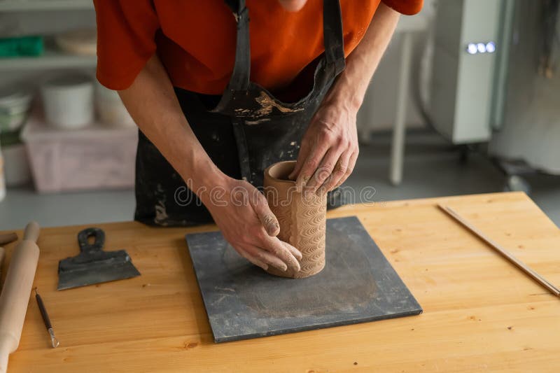 Close-up of a Man& X27;s Hands Making a Patterned Cylinder Out of Clay ...