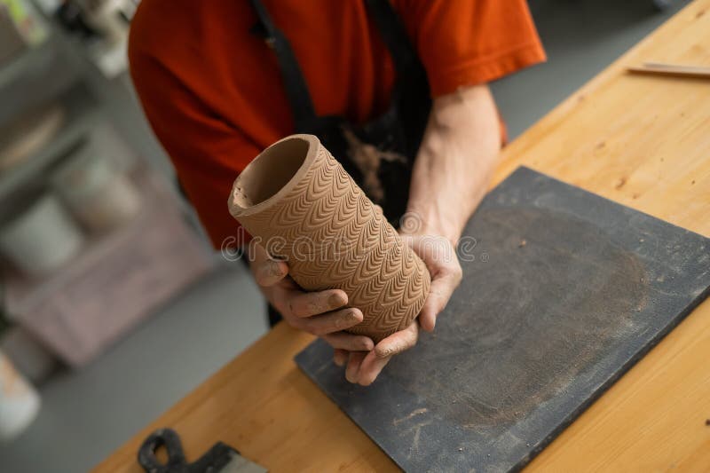 Close-up of a Man& X27;s Hands Making a Patterned Cylinder Out of Clay ...