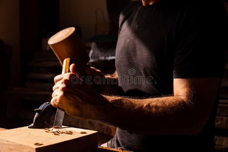 Close Up of Man& X27;s Hands Using a Chisel and a Mallet on a Piece of ...