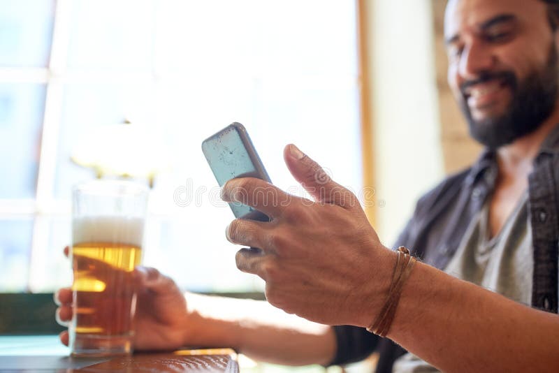 Close Up of Man with Smartphone and Beer at Pub Stock Image - Image of ...