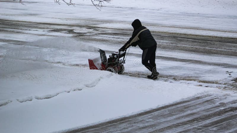 Close-up of Man in Snow Clearing in Front of Yard with Snowblower Stock ...