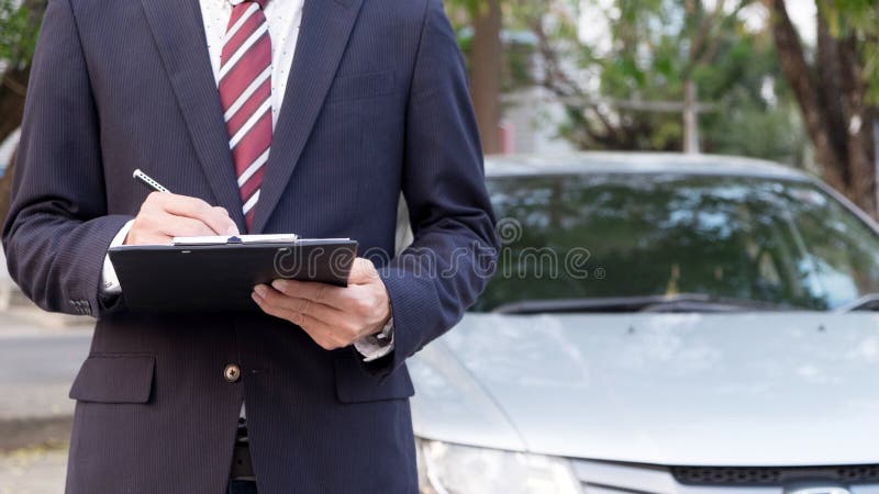 Close-up of a Man Standing in Front of Car Holding Clipboard in Stock ...