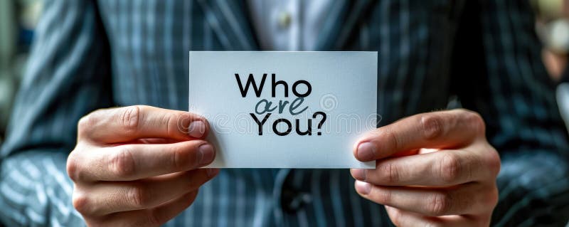 Close Up of a Man in a Suit Holding a Card with Who are You? Printed on ...