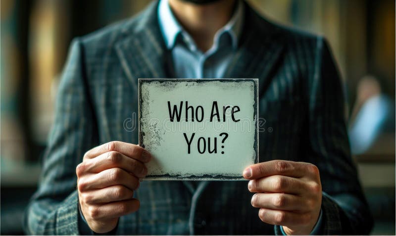 Close Up of a Man in a Suit Holding a Card with Who are You? Printed on ...