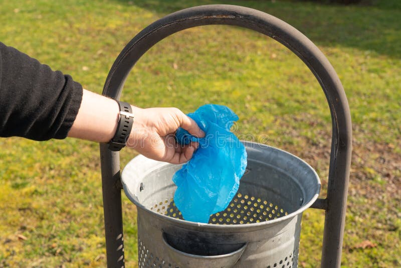 Close-up of Man Throwing Away Trash in Garbage Container Stock Photo ...