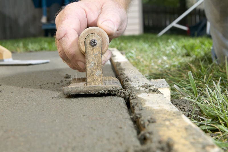 Close Up of a Man Using Edging Tool on Wet Cement Stock Photo - Image ...