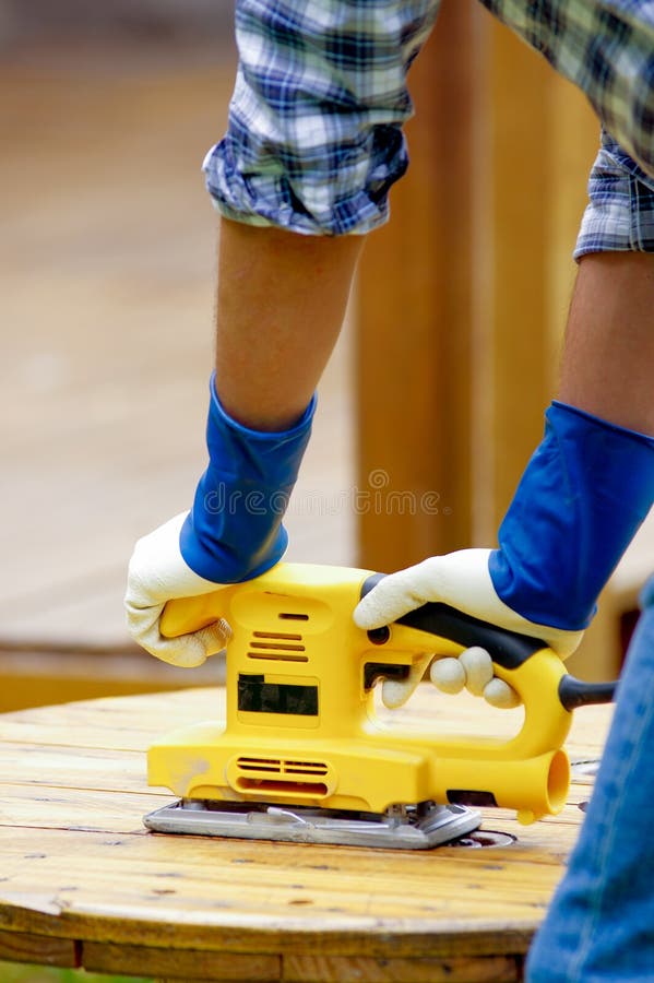 Close Up of a Man Using an Electric Sander on Pine Floor or Table ...