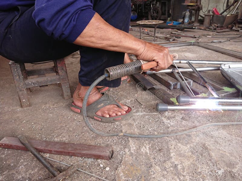Close Up, Man Welding Broken Chair at His Workshop Stock Image - Image ...