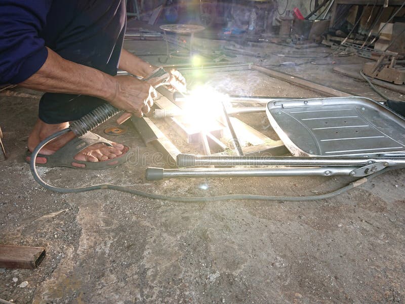 Close Up, Man Welding Broken Chair at His Workshop Stock Photo - Image ...