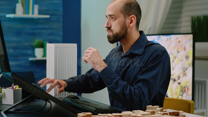 Close Up of Man Working on Computer with Building Model Stock Image ...