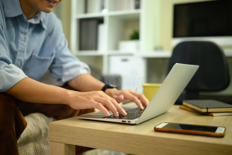 Close Up of Man Working on Laptop at Home, Focusing on Hands Typing on ...